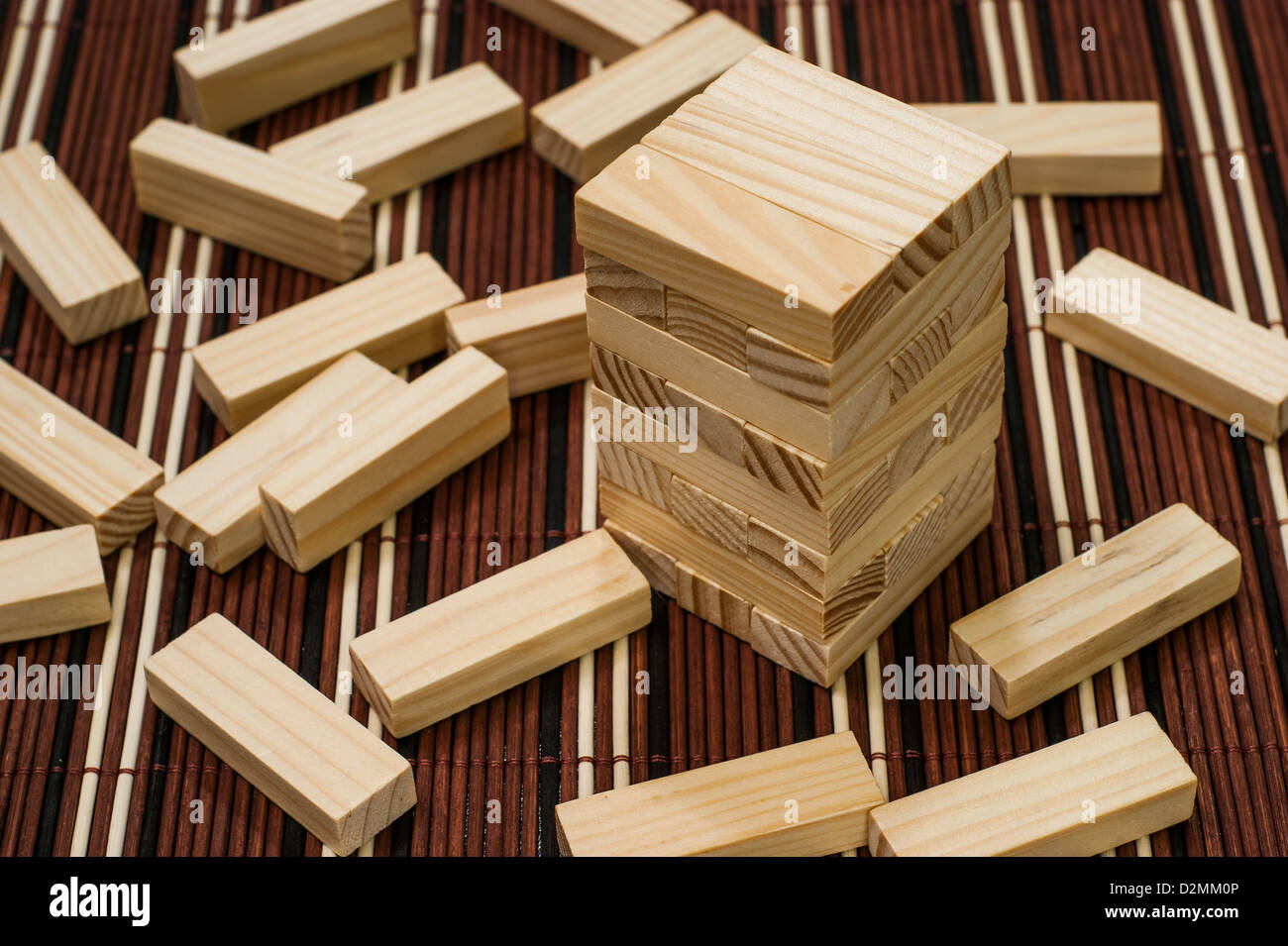 Wooden blocks tower and block spread around Stock Photo - Alamy