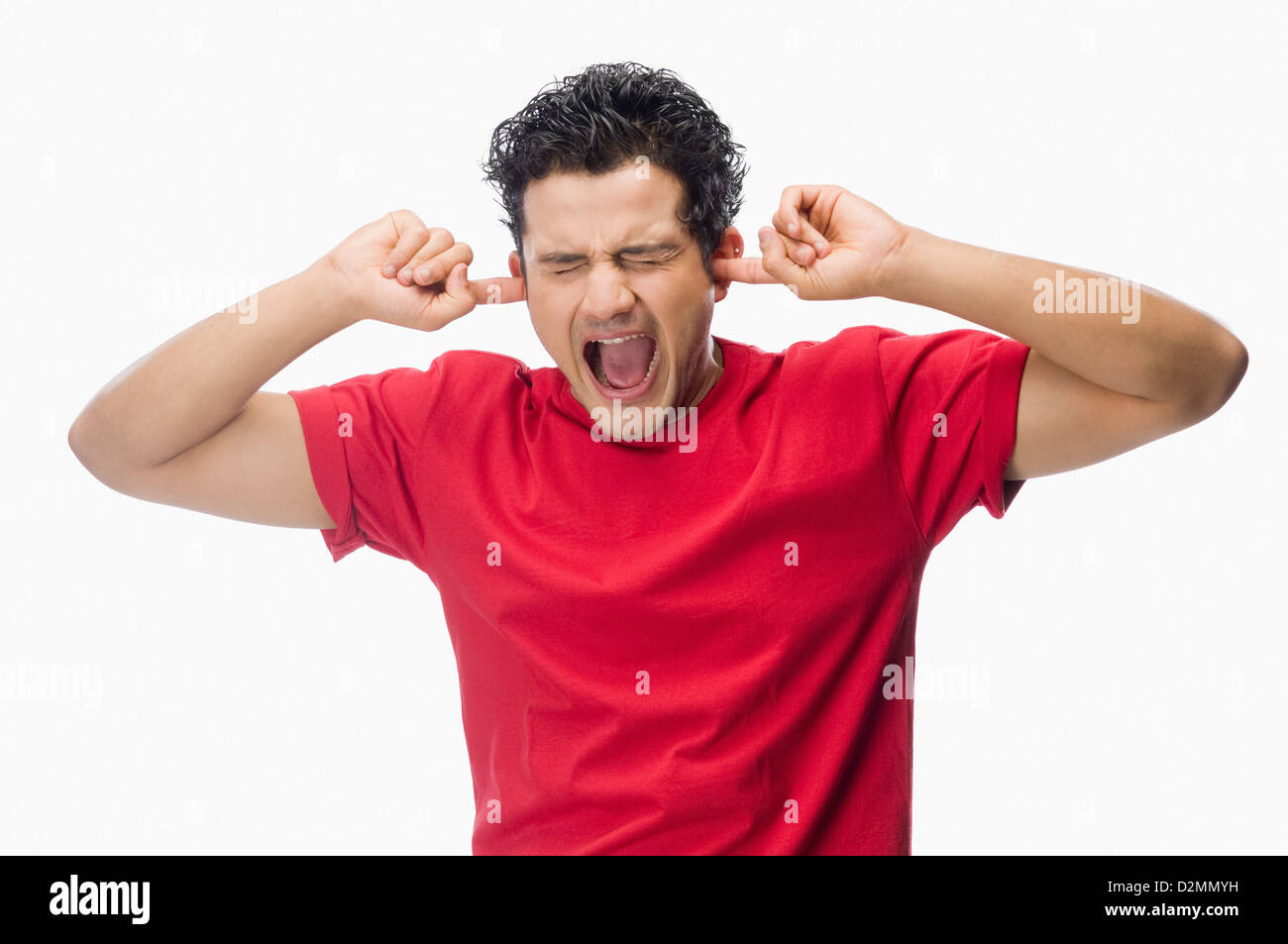 Man screaming with his fingers in ears Stock Photo - Alamy