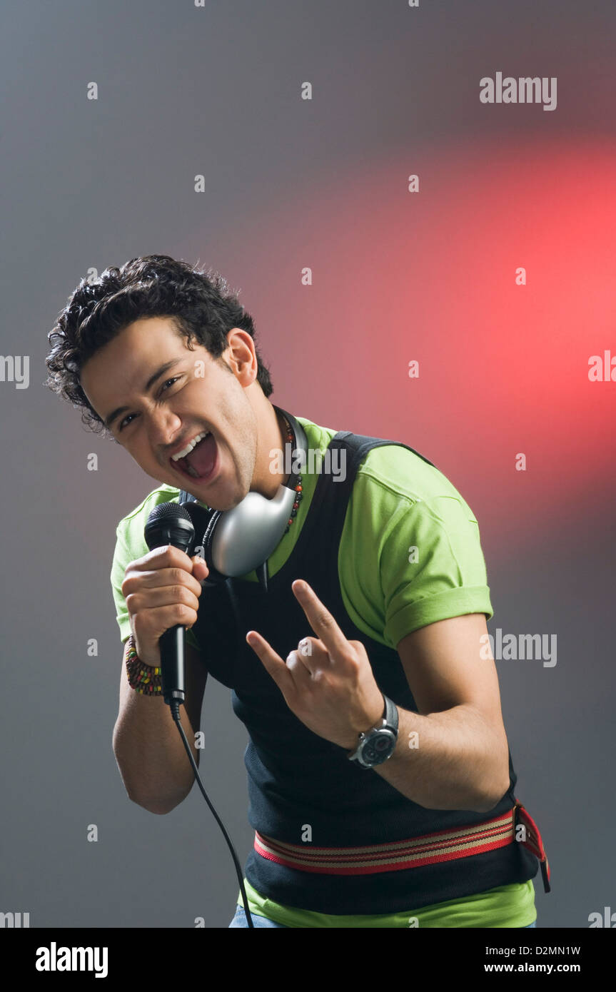 Man singing into a microphone Stock Photo - Alamy