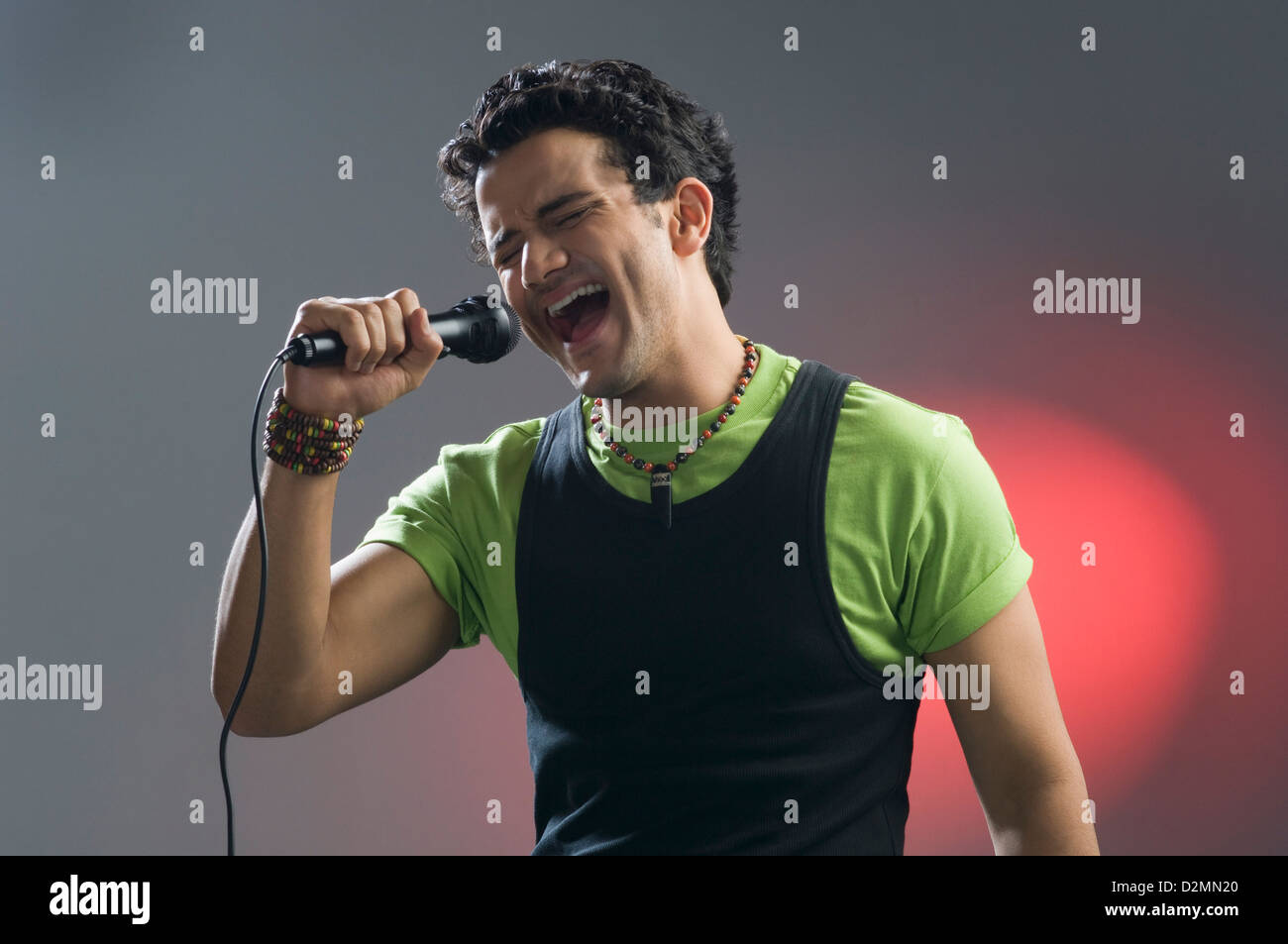 Man singing into a microphone Stock Photo - Alamy