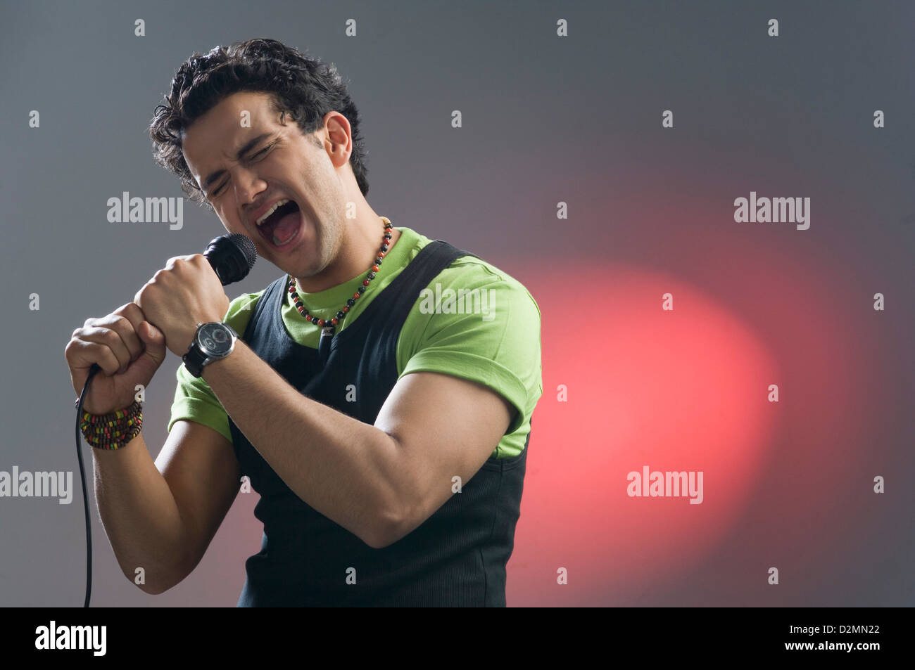 Man singing into a microphone Stock Photo - Alamy