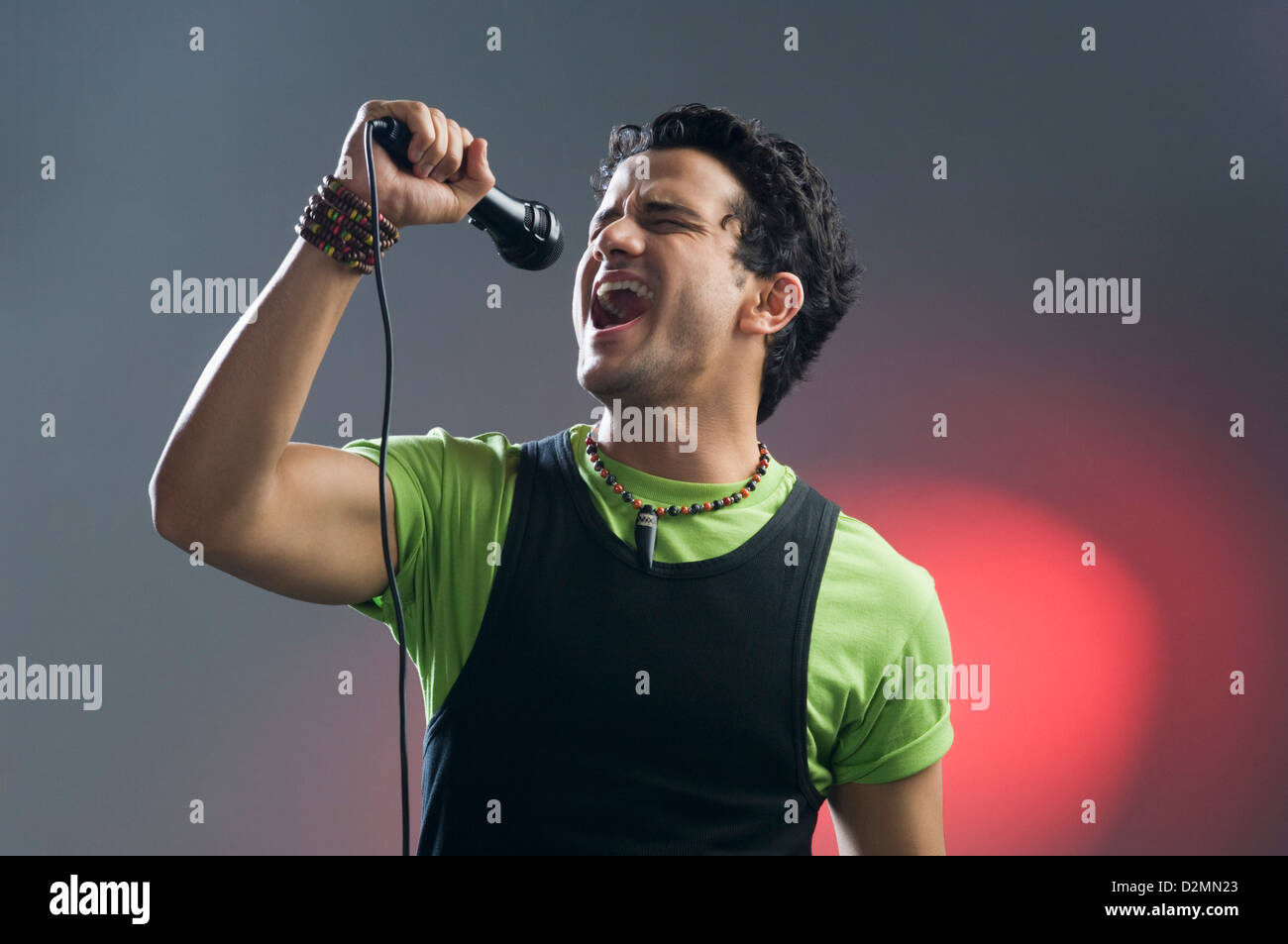Man singing into a microphone Stock Photo - Alamy
