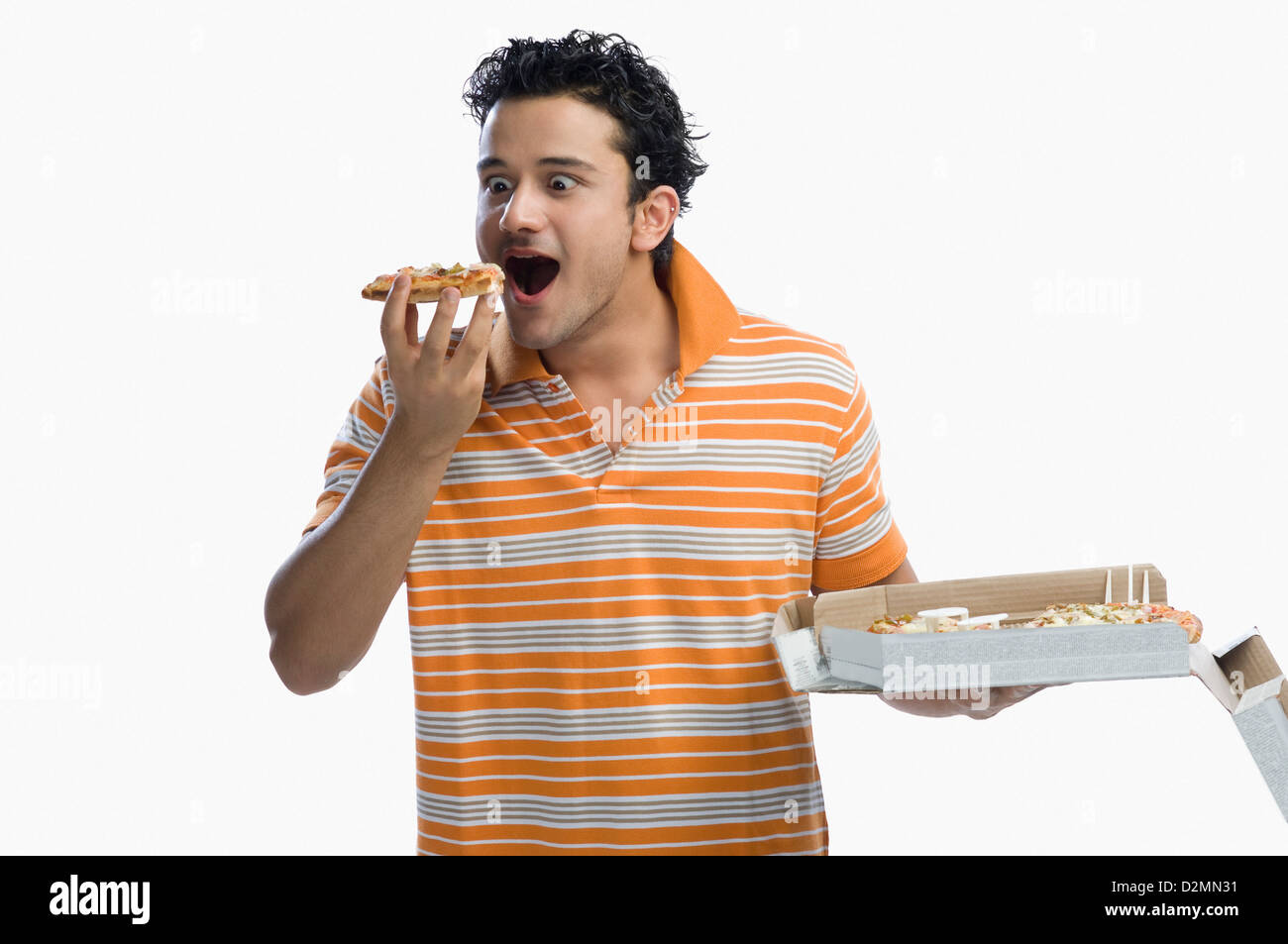 Close-up of a man eating pizza Stock Photo - Alamy