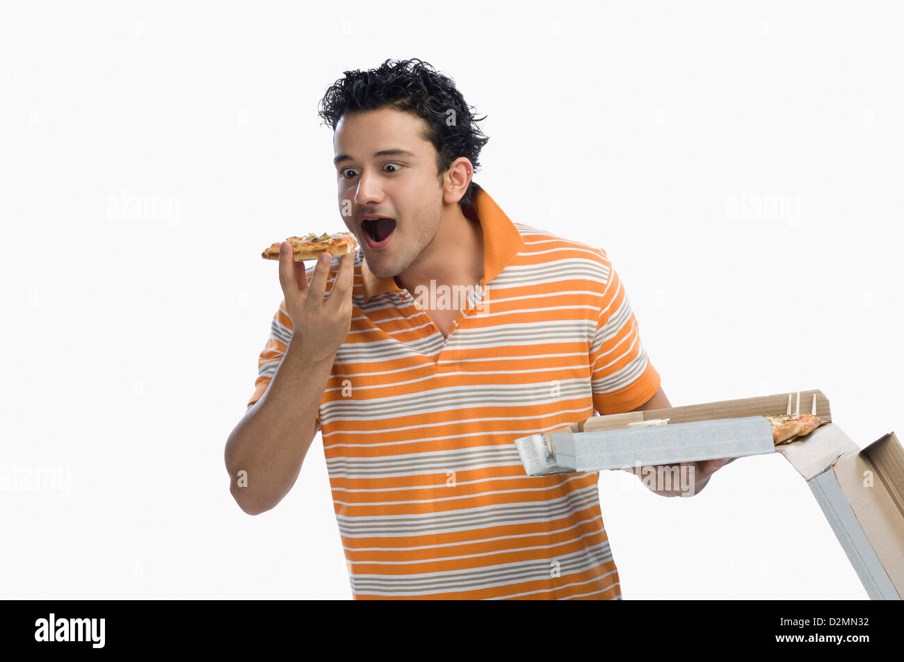Close-up of a man eating pizza Stock Photo - Alamy