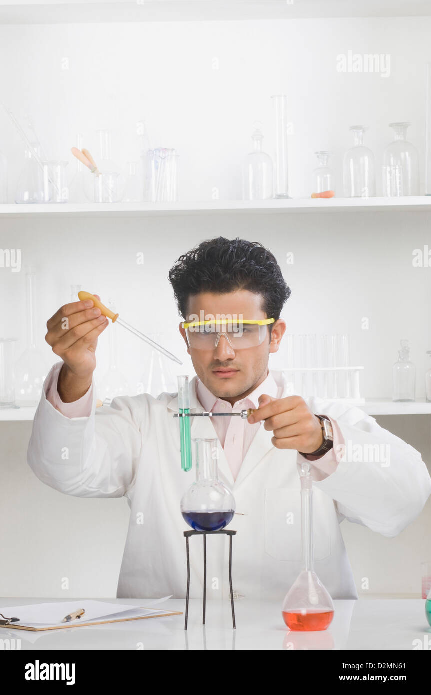 Scientist experimenting in a laboratory Stock Photo - Alamy