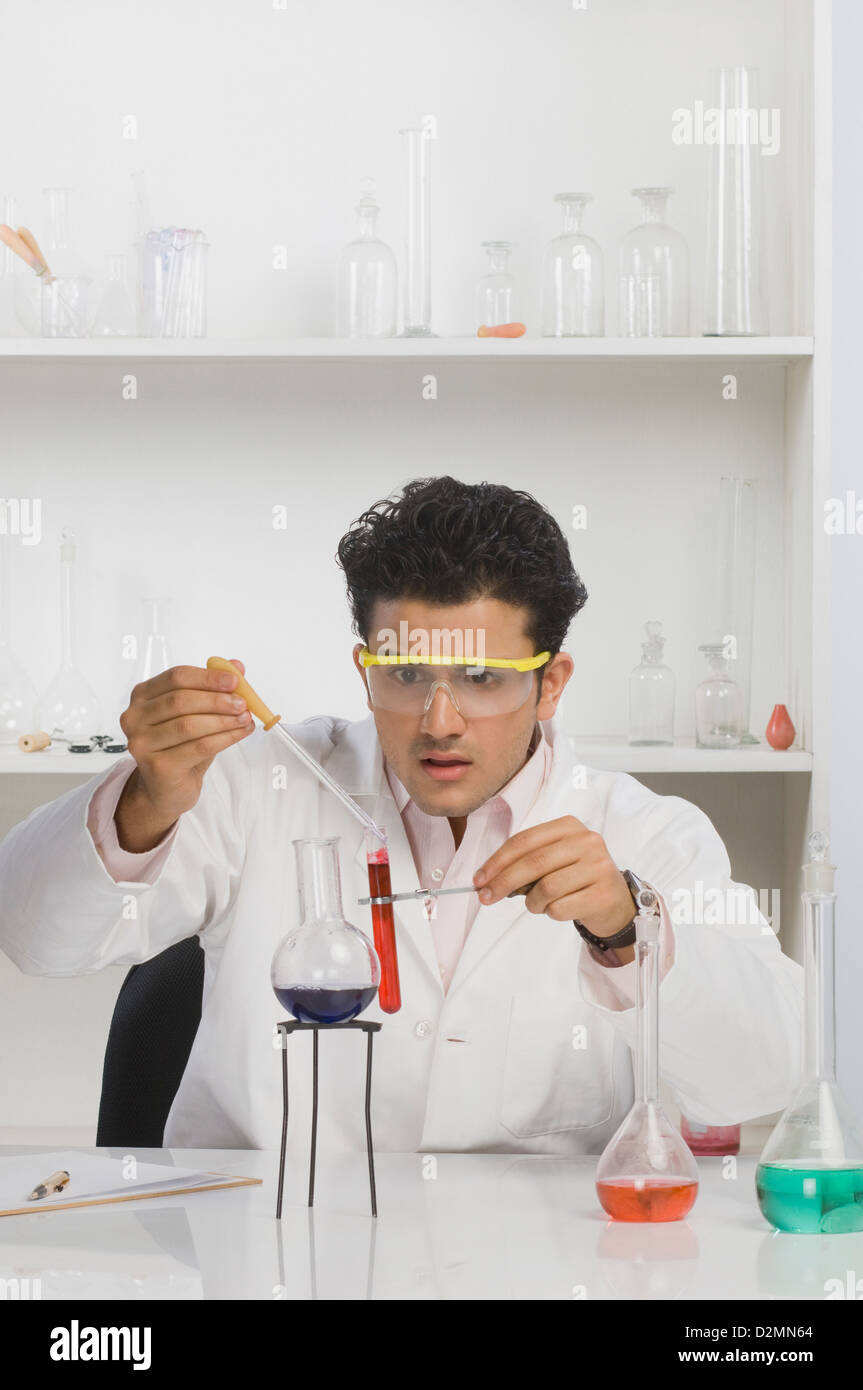 Scientist experimenting in a laboratory Stock Photo - Alamy