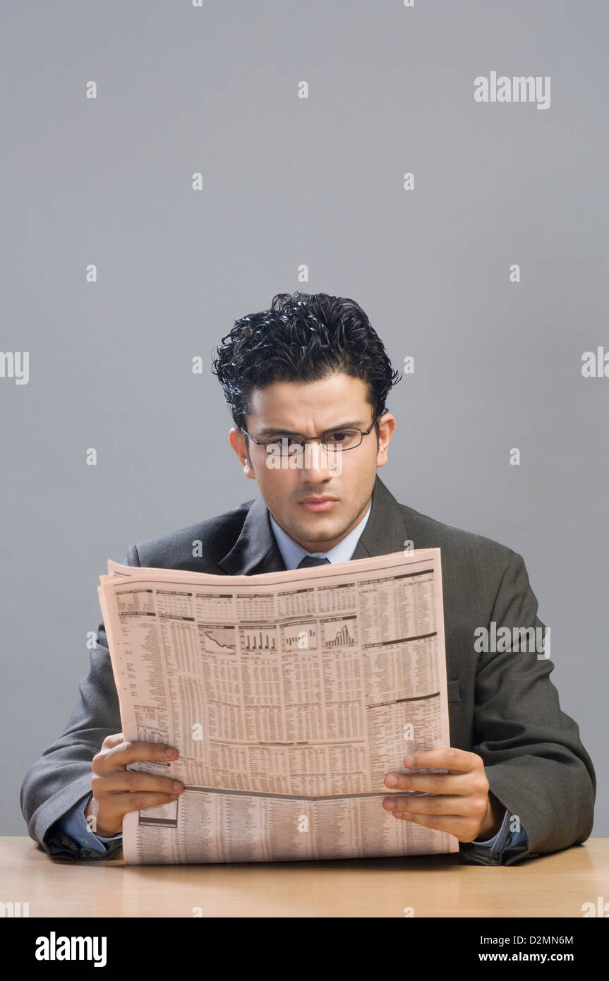 Man sitting at desk reading a newspaper hi-res stock photography and ...