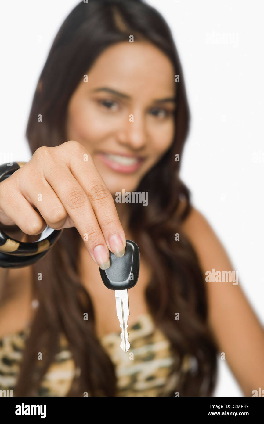 Portrait of a woman showing a car key Stock Photo - Alamy