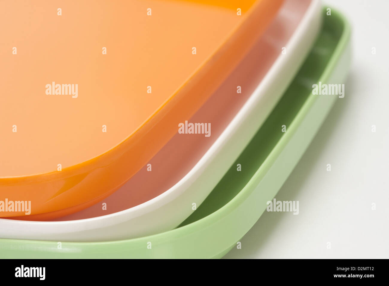 Close-up of a stack of colorful trays representing Indian flag colors ...