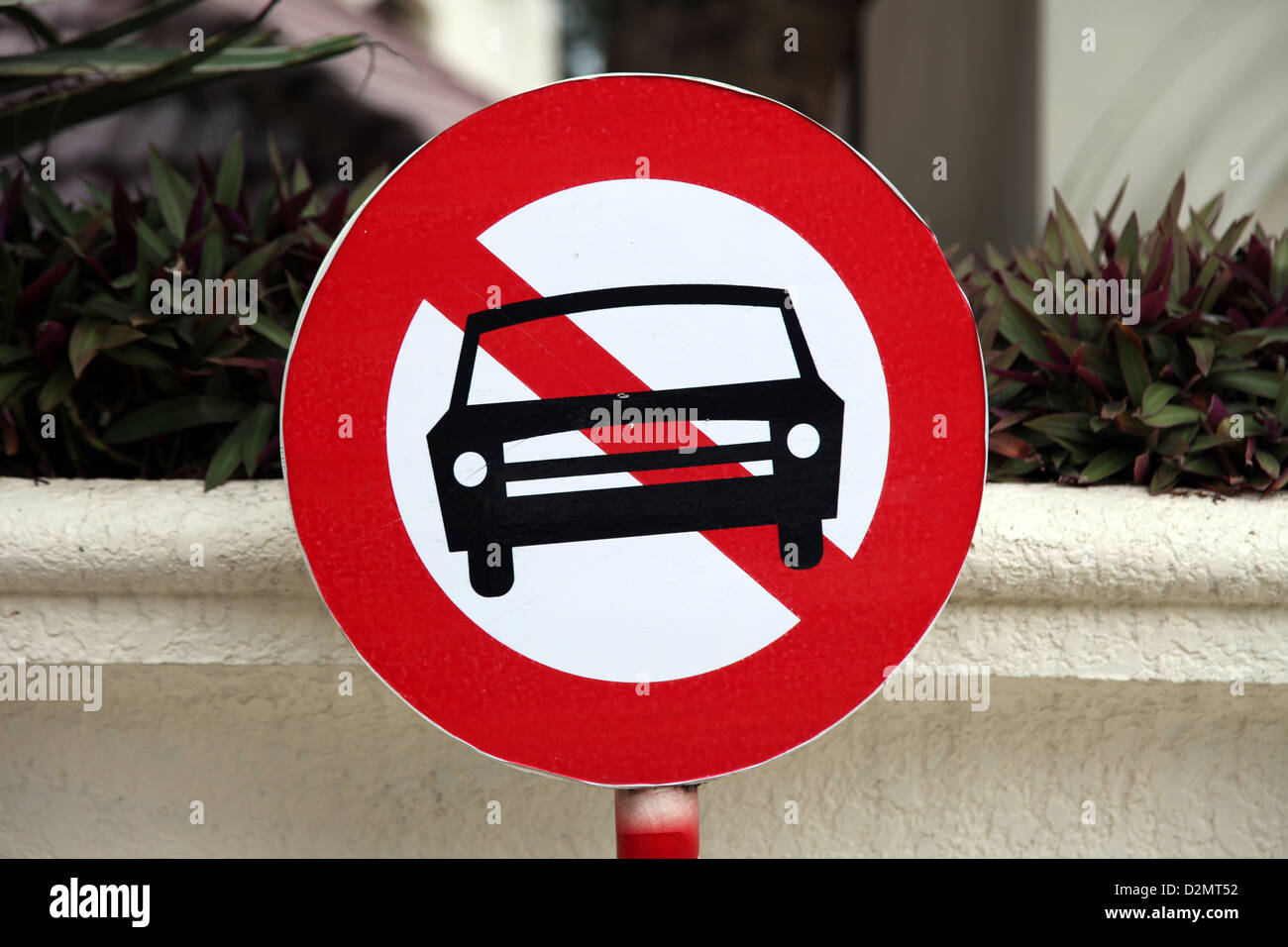 It's a photo of a road sign which says forbidden for cars to park or ...
