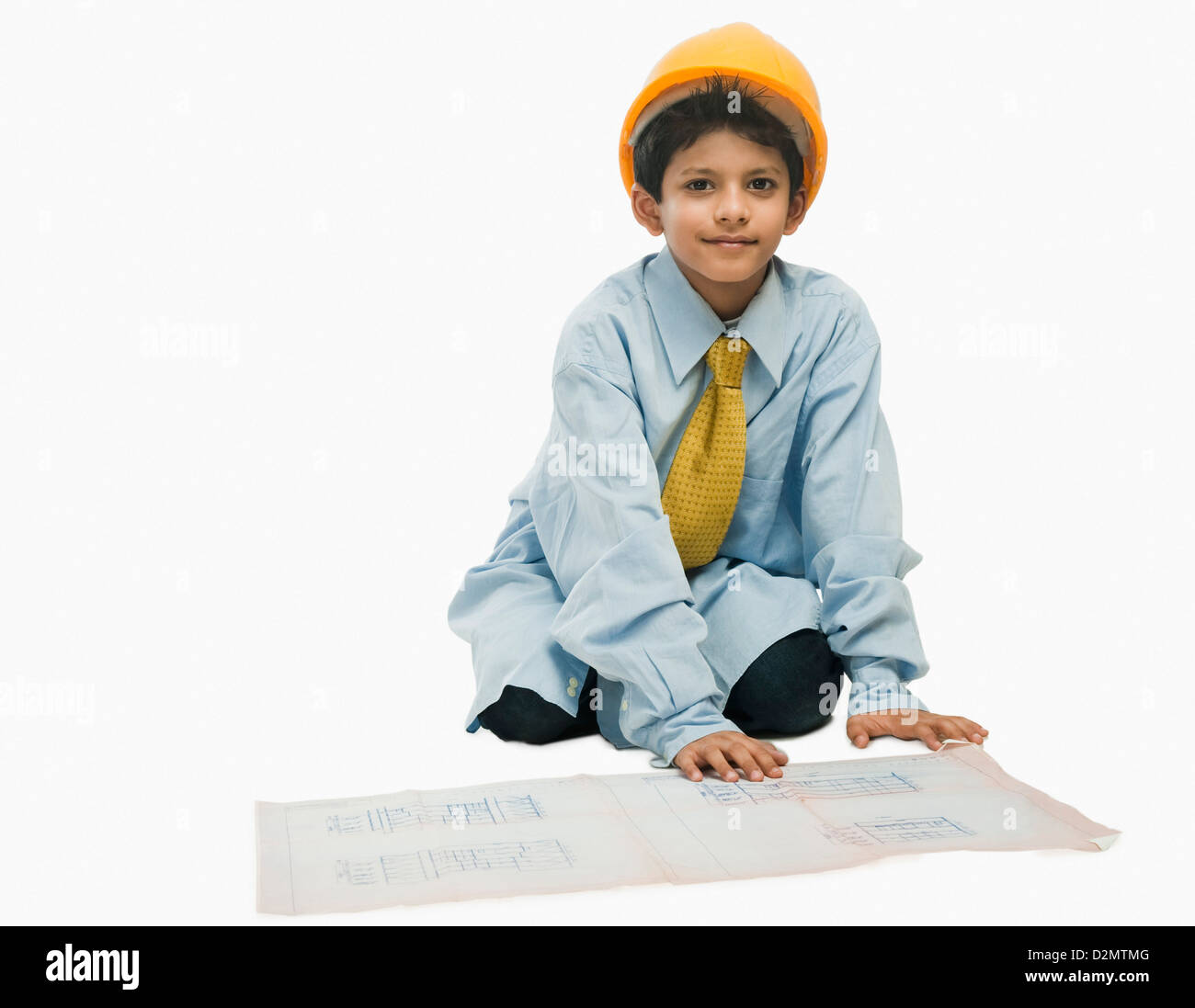 Boy dressed as an architect and working on a blueprint Stock Photo - Alamy