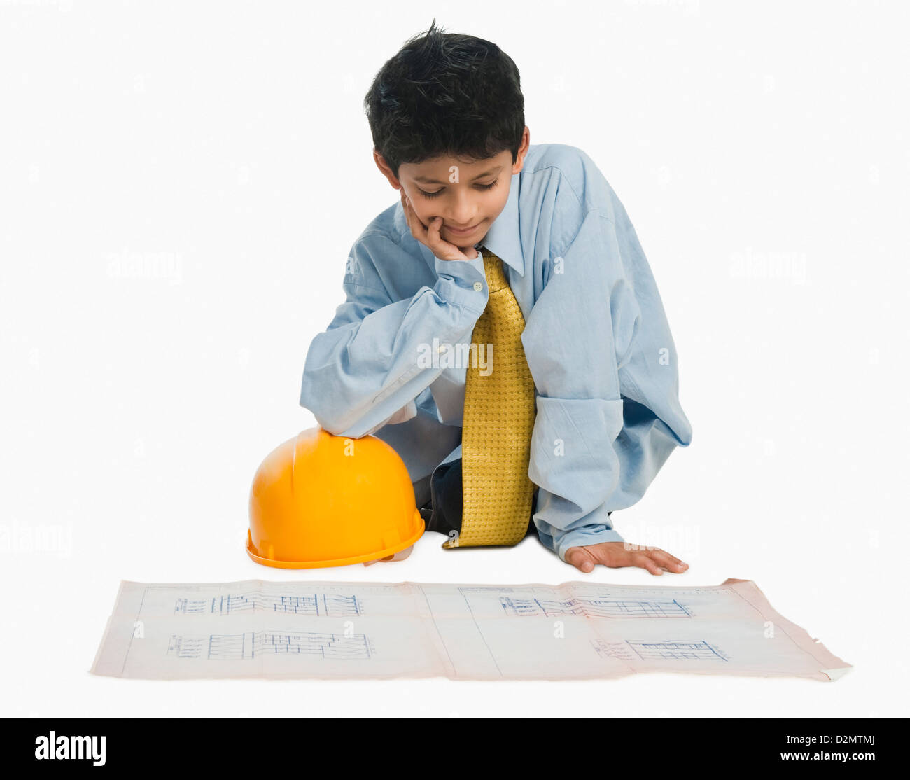 Boy dressed as an architect and working on a blueprint Stock Photo - Alamy