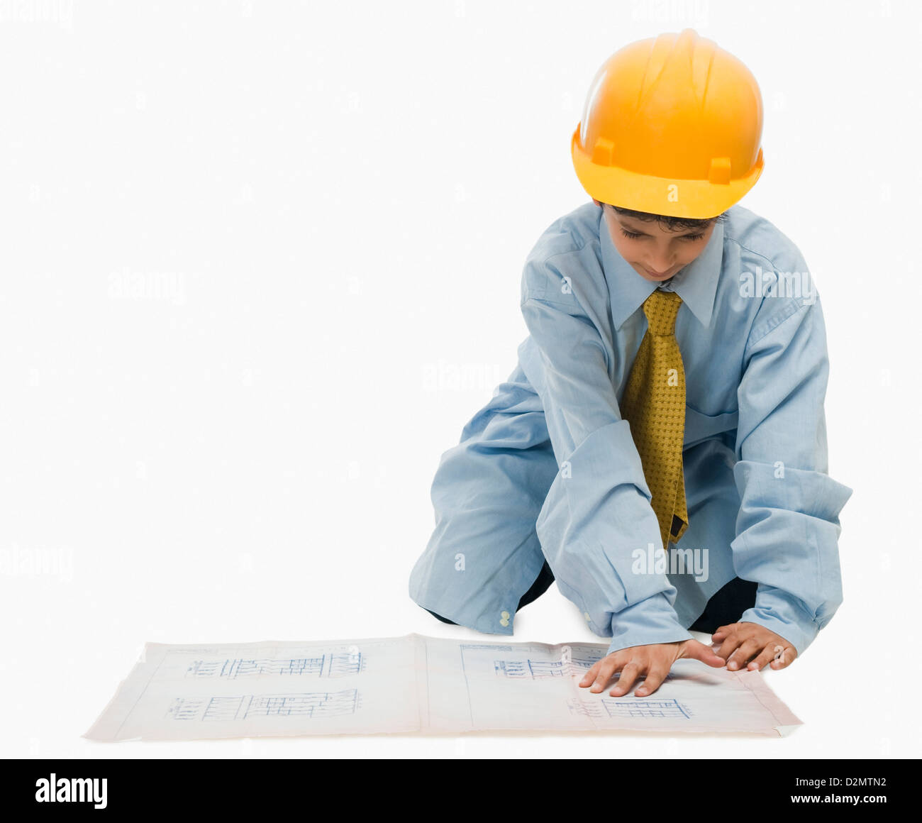 Boy dressed as an architect and working on a blueprint Stock Photo - Alamy