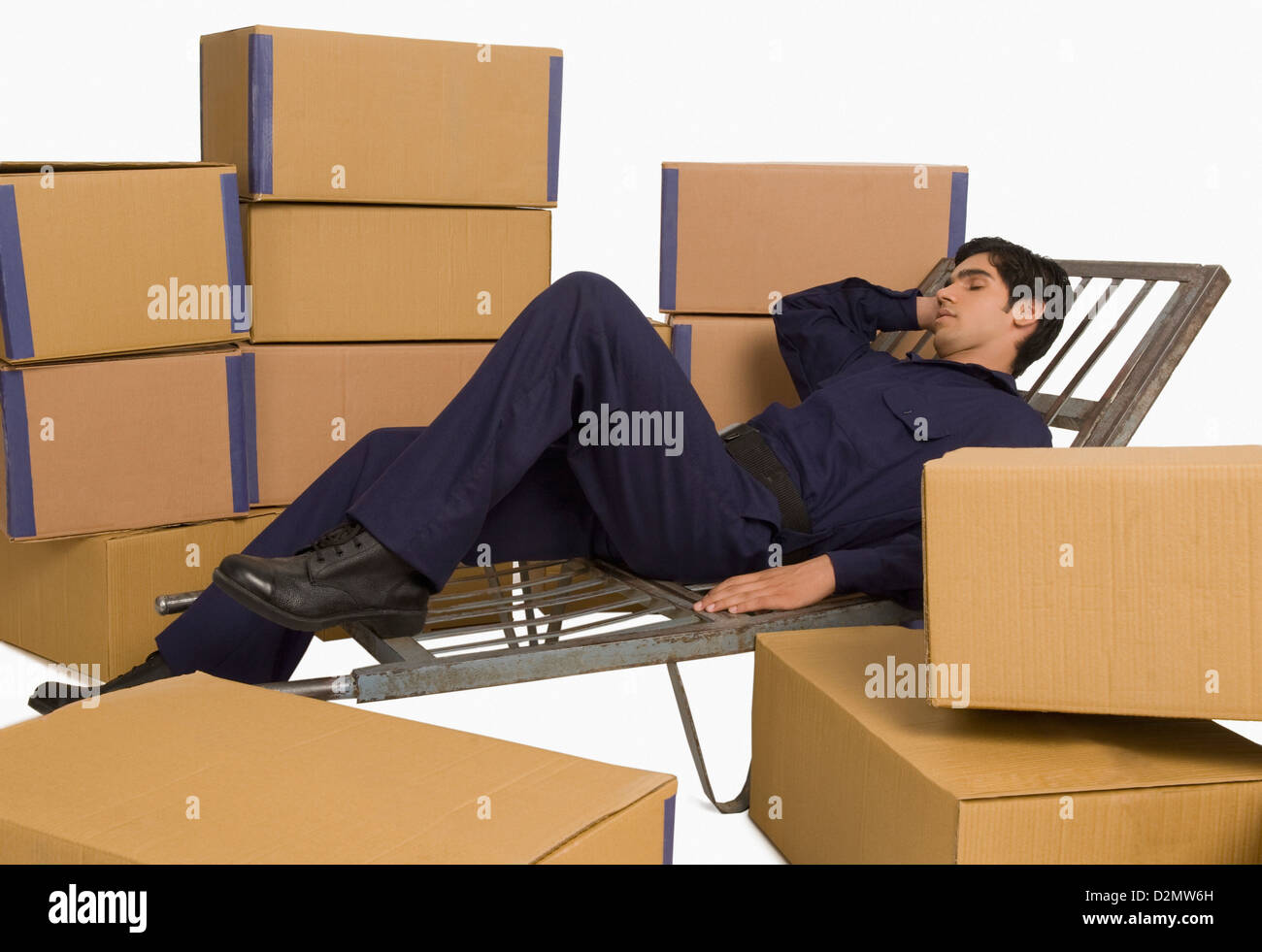Store incharge sleeping on a hand truck in a warehouse Stock Photo - Alamy