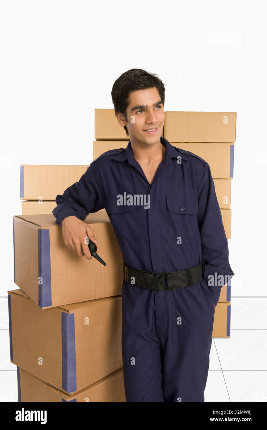 Store incharge leaning against cardboard boxes in a warehouse Stock ...