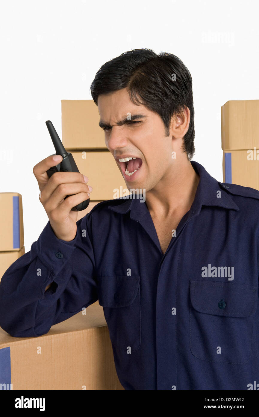 Store incharge shouting on a walkie-talkie Stock Photo - Alamy