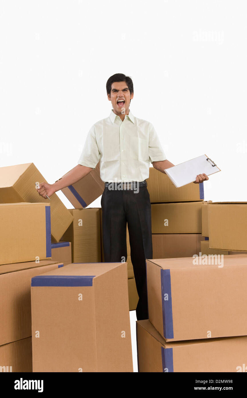 Store incharge standing among cardboard boxes and shouting Stock Photo ...