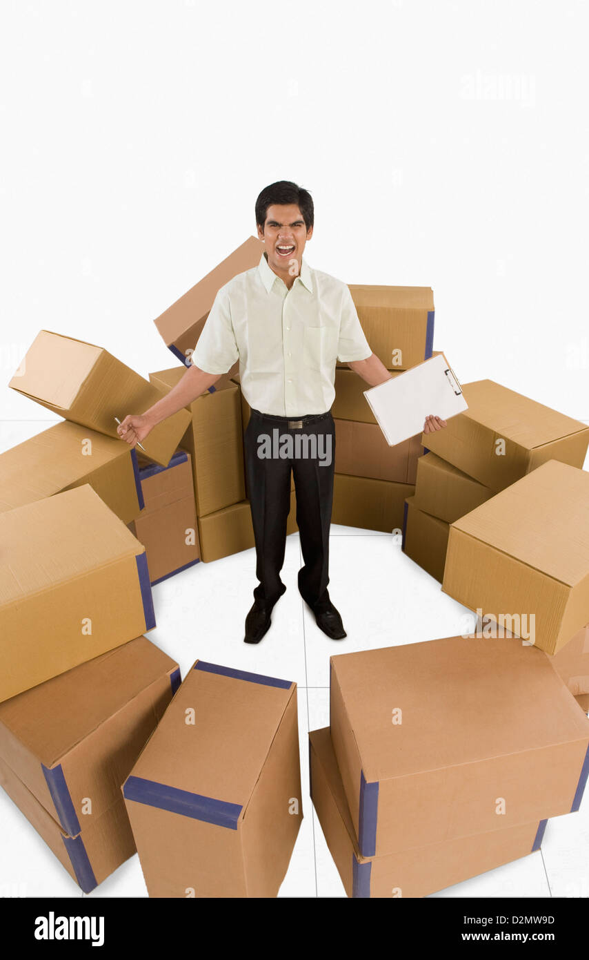 Store incharge standing among cardboard boxes and shouting Stock Photo ...