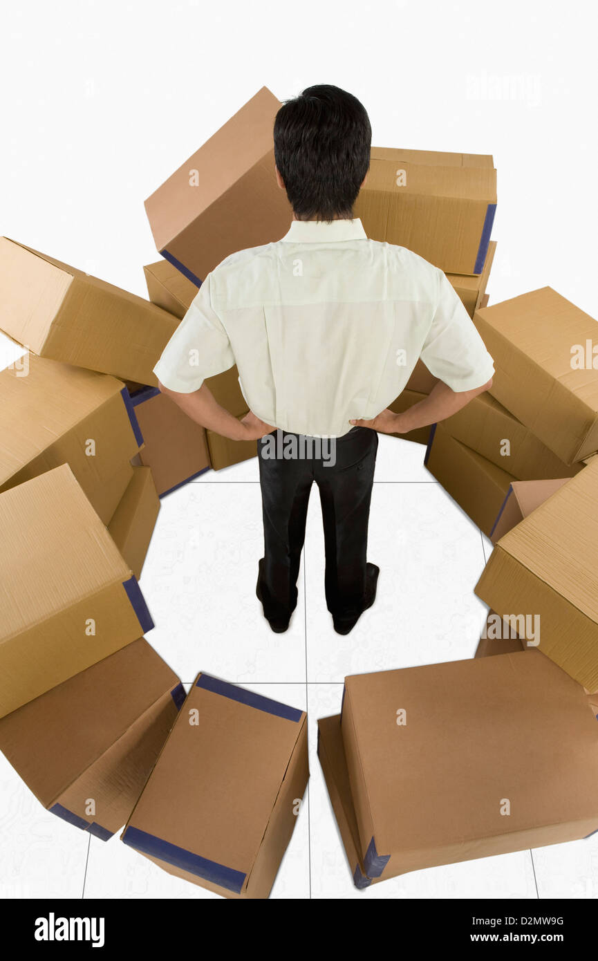 Store incharge surrounded by cardboard boxes Stock Photo - Alamy