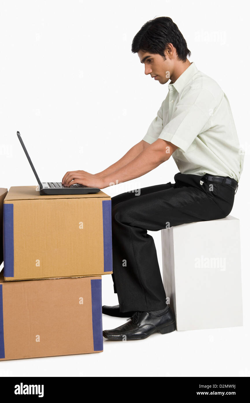 Store incharge using a laptop in a warehouse Stock Photo - Alamy