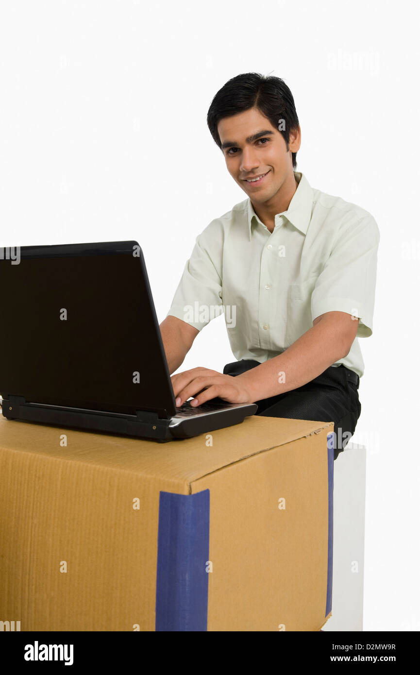 Store incharge using a laptop in a warehouse Stock Photo - Alamy