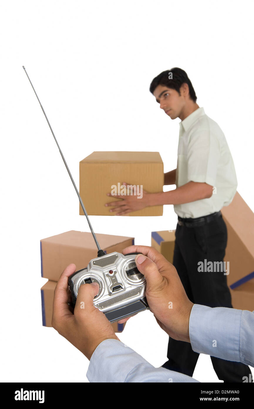 Person's hands controlling a worker with a remote control Stock Photo ...