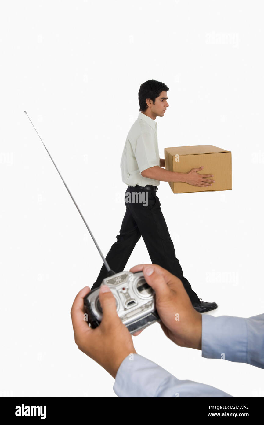 Person's hands controlling a worker with a remote control Stock Photo ...