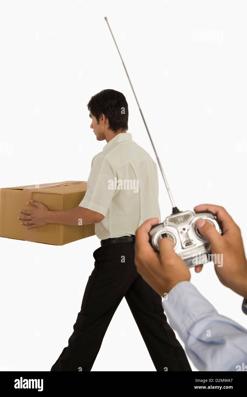 Person's hands controlling a worker with a remote control Stock Photo ...