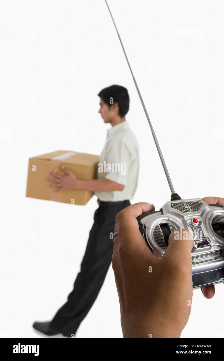 Person's hands controlling a worker with a remote control Stock Photo ...