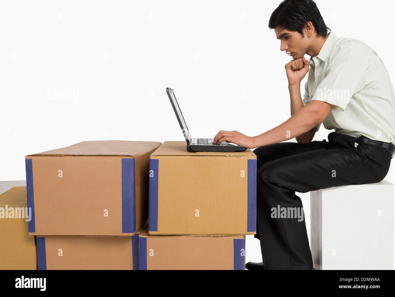 Store incharge using a laptop in a warehouse Stock Photo - Alamy