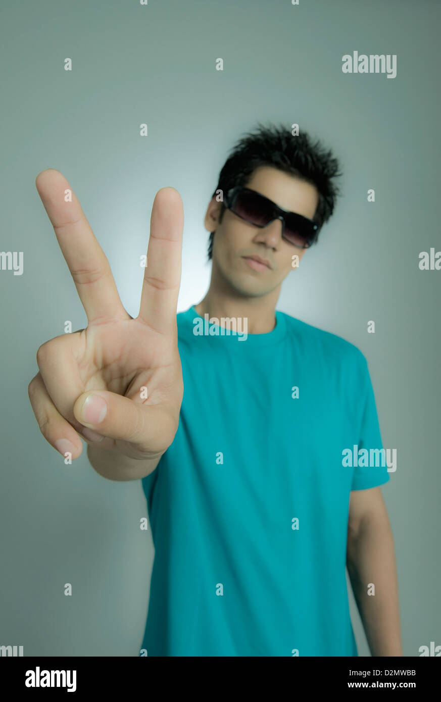 Indian man showing victory symbol hi-res stock photography and images ...