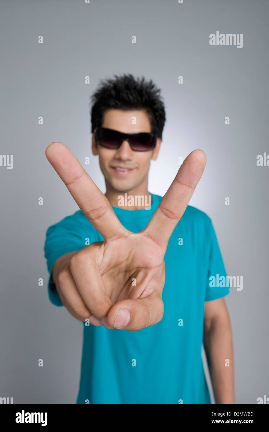Indian man showing victory symbol hi-res stock photography and images ...
