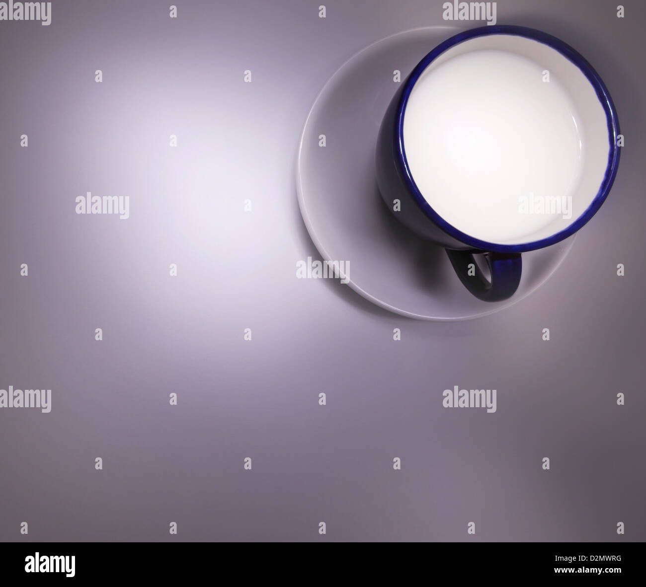 One blue cup of milk in the corner on gray illuminated background Stock ...