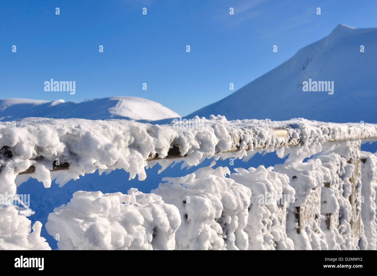 closeup snow covering a railing in front of a panorama terrace under a ...