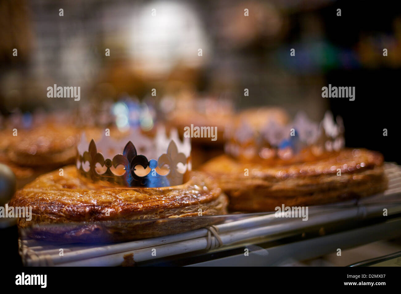 Traditional Galette des Rois pastries adorned with crowns, displayed in ...
