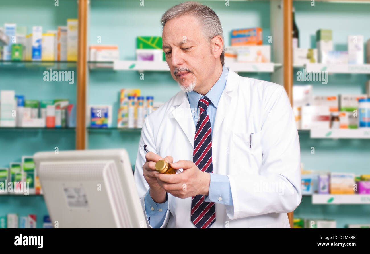 Pharmacist at work in his pharmacy Stock Photo - Alamy
