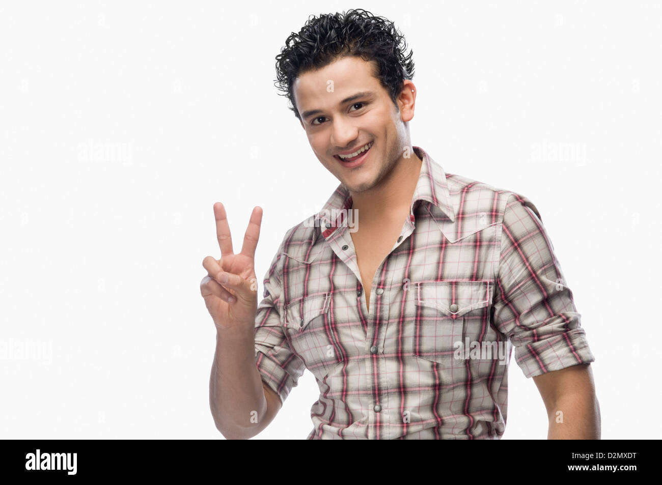 Portrait of a man showing victory sign Stock Photo - Alamy