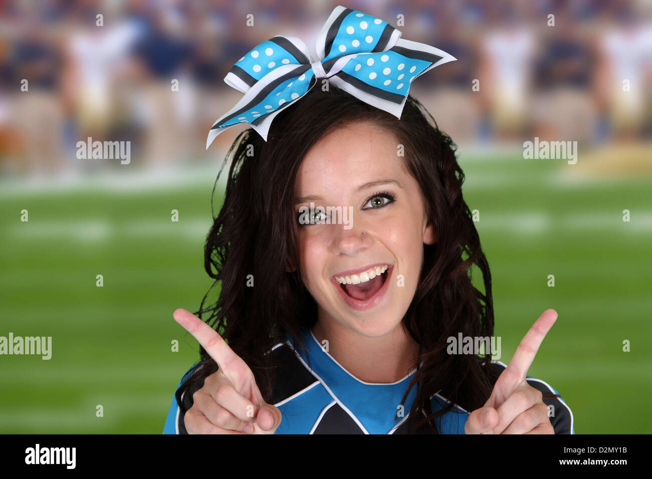 Cheerleader with uniform on at a football game Stock Photo - Alamy