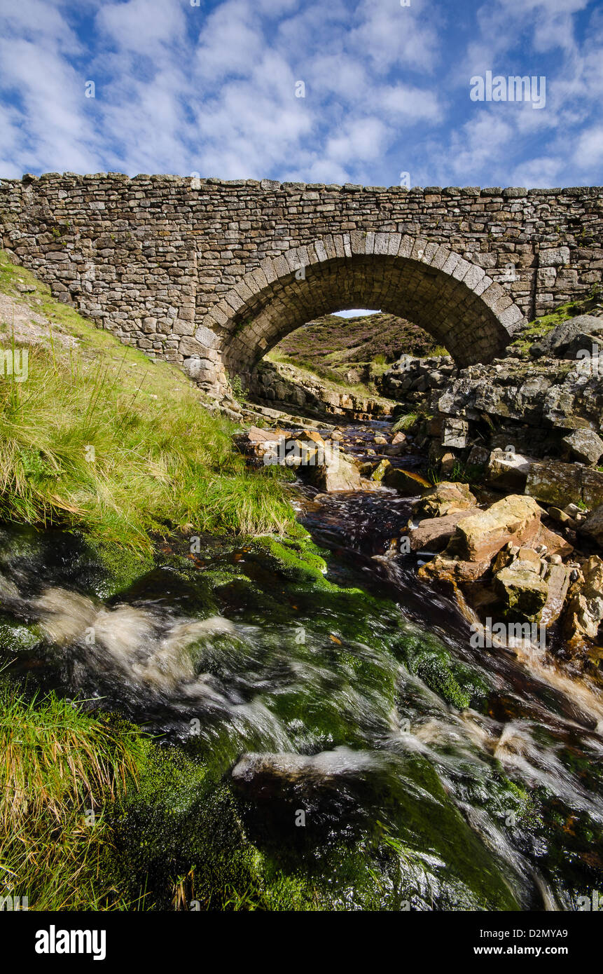 Stone bridge over a fast flowing stream Stock Photo - Alamy