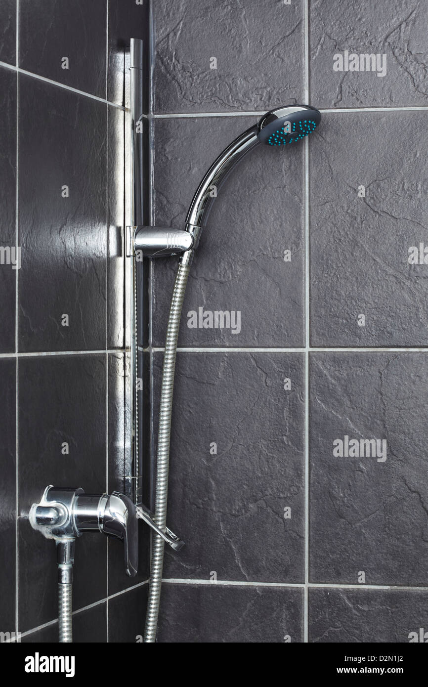 Shower in contemporary grey tiled bathroom Stock Photo - Alamy