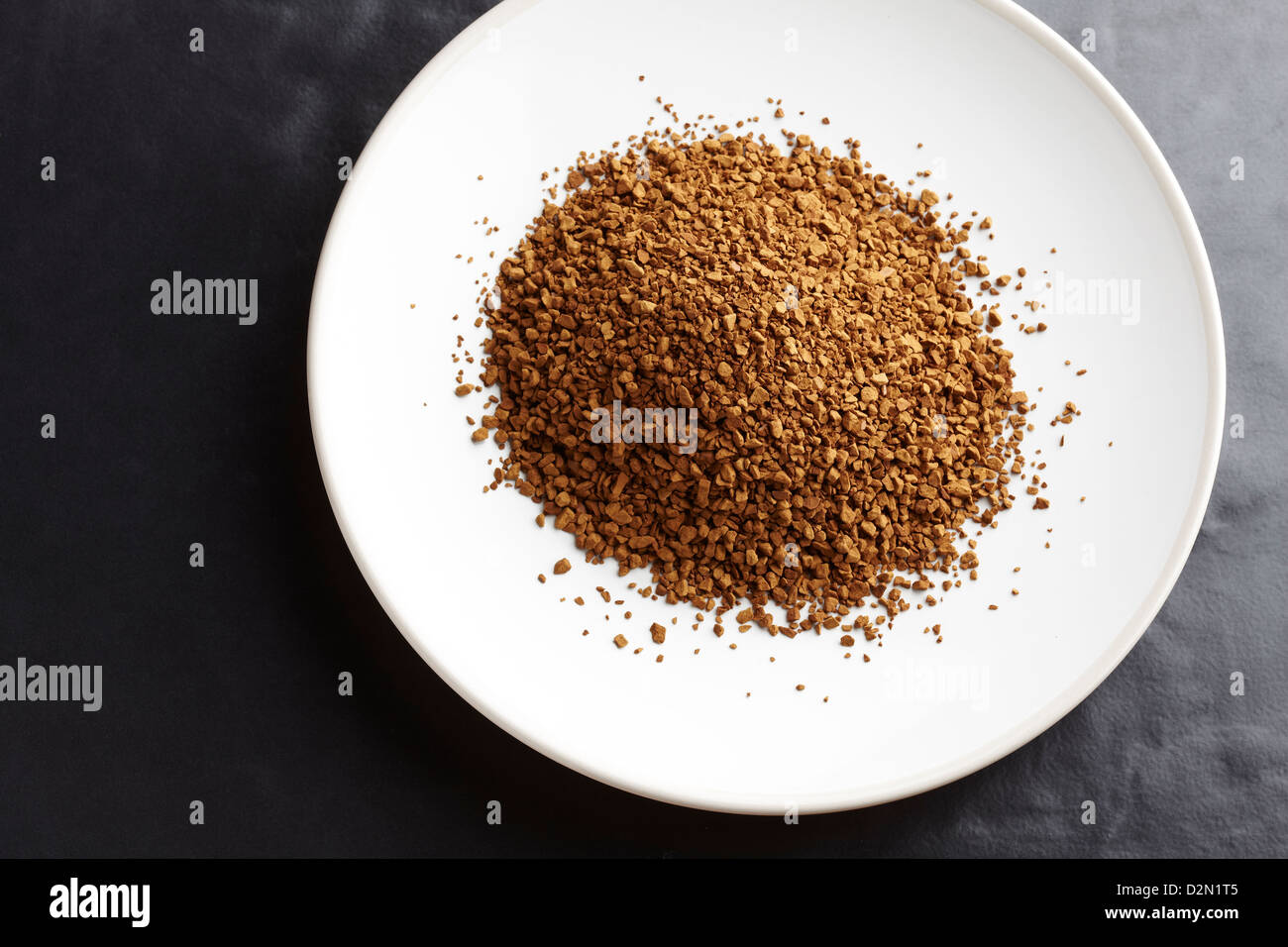 Instant coffee granules on white plate Stock Photo - Alamy