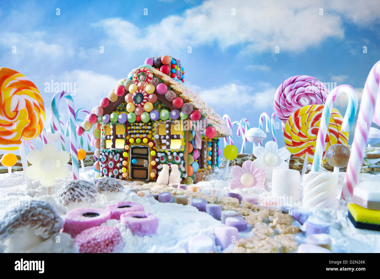 Gingerbread house in christmas landscape surrounded by candy canes and ...