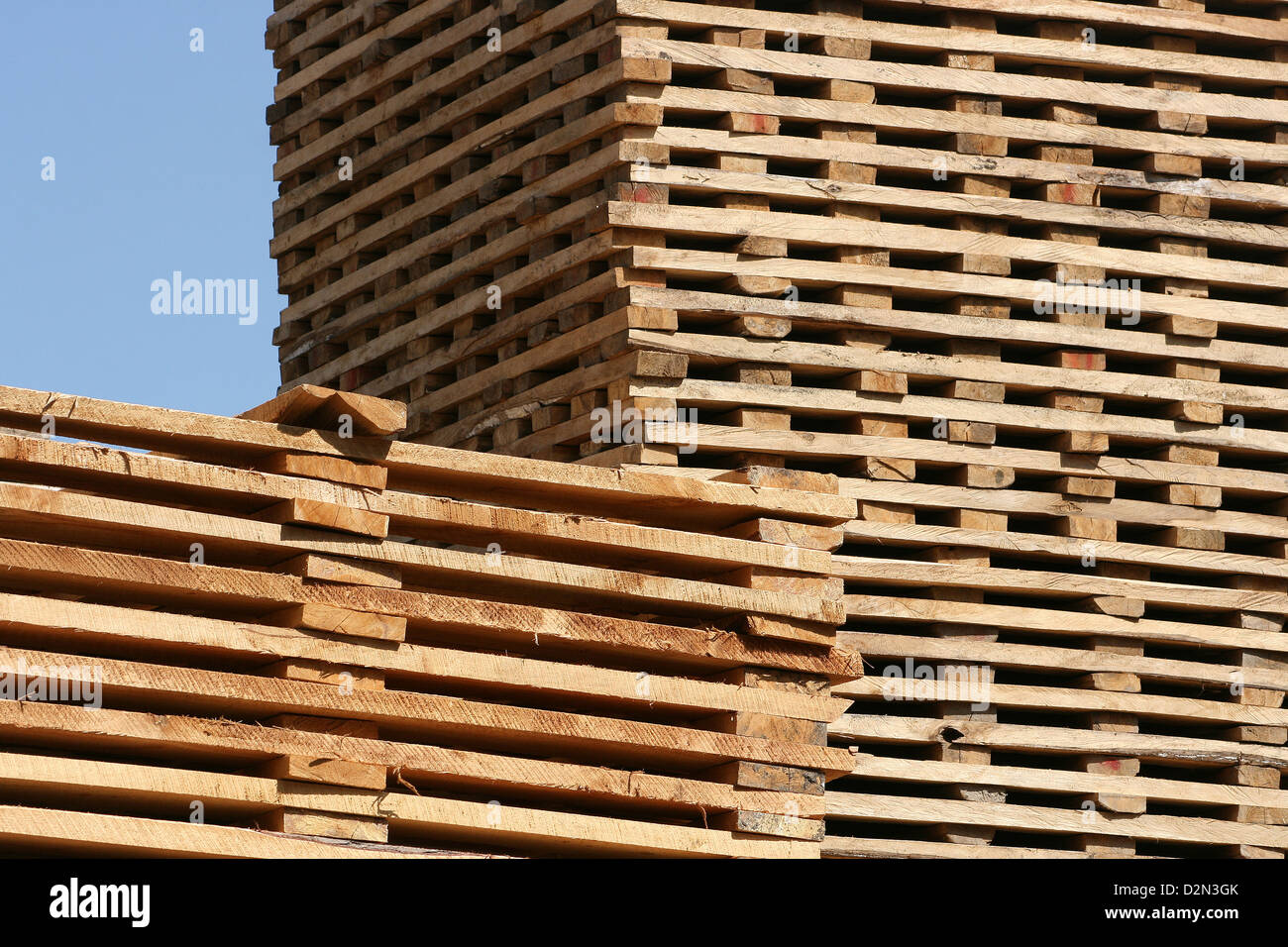 Stacks of freshly cut boards are stacked to dry at an outdoor sawmill ...