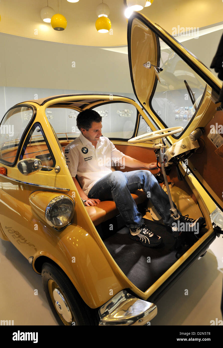 Racing driver Timo Glock sits in a BMW Isetta vintage car at BMW in ...
