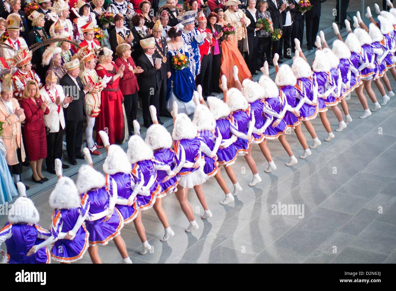 (HANDOUT) A handout shows German Chancellor Angela Merkel (C) receiving ...