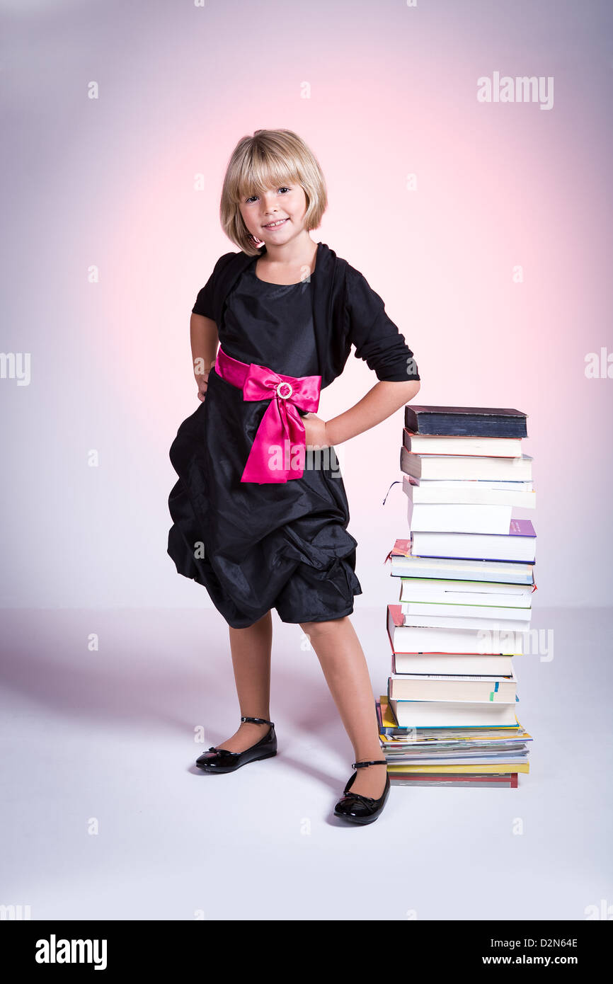 first grade school girl with a stack of books Stock Photo - Alamy