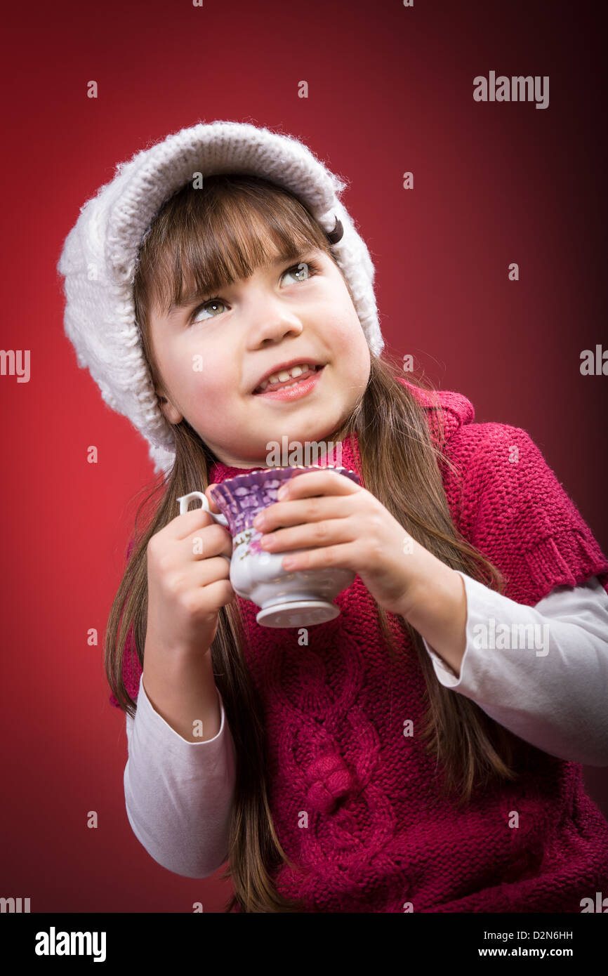 studio portrait of young girl with a cup Stock Photo - Alamy