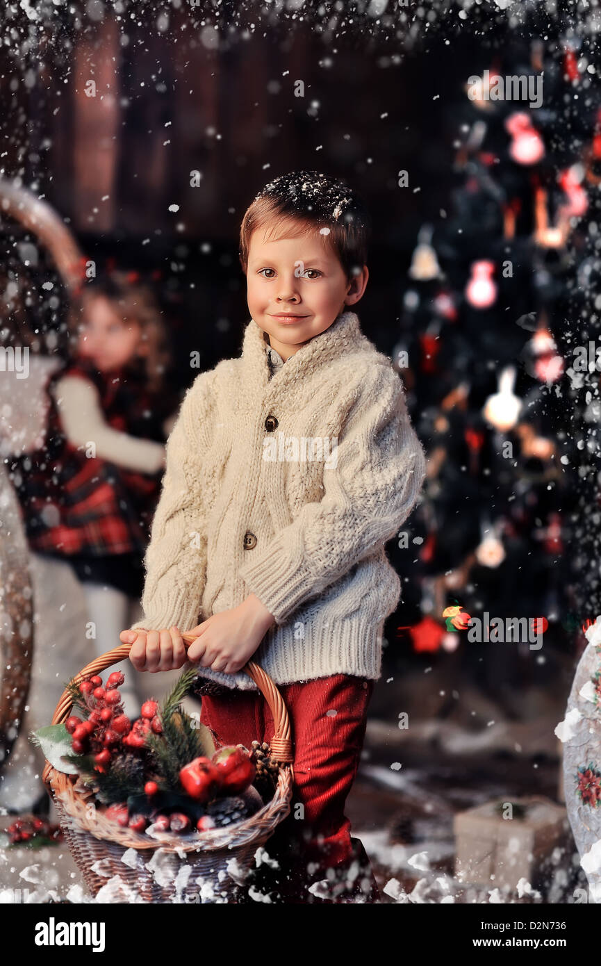 boy with a basket of toys in the background of a beautiful Christmas ...