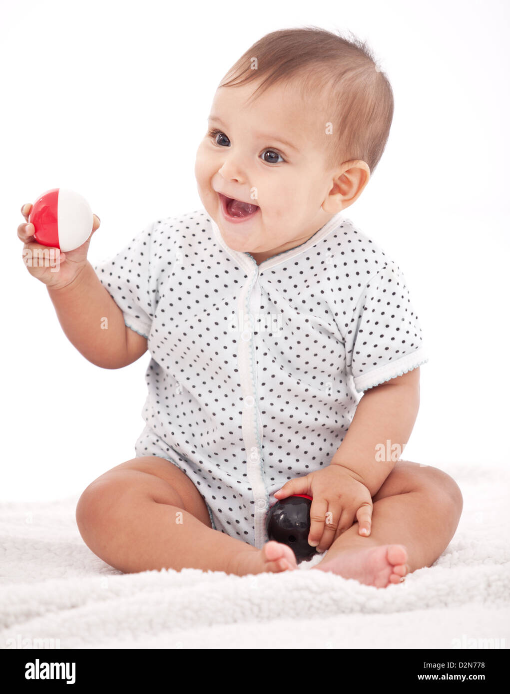 Happy 7-monthes baby girl playing with balls Stock Photo - Alamy