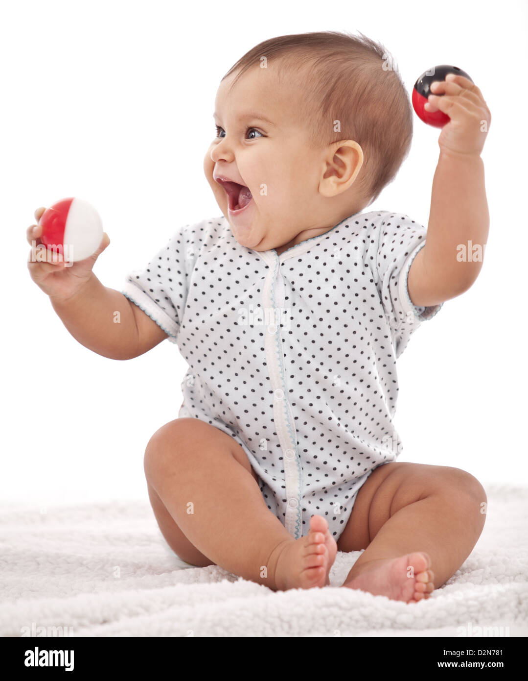 Happy baby girl playing with balls Stock Photo - Alamy